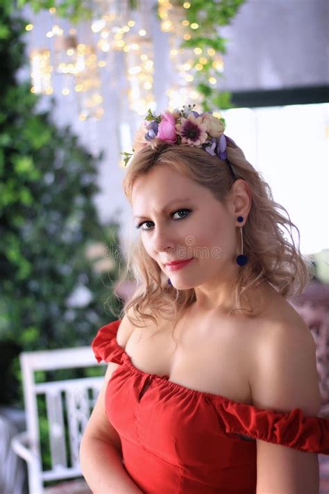 Portrait Of Beautiful Blonde Photomodel With High Bosom In Red Dress
