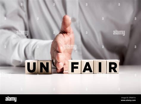 Businessman Hand Puts Away The First Two Letters From The Word Unfair And Transforms It Into