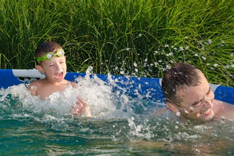 Father And Son Having Fun In The Swimming Pool Stock Image Image Of