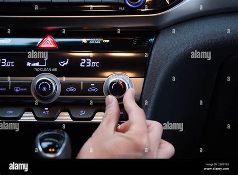 Hand Turning On Cars Air Conditioner Dial Hand Adjusting Heater