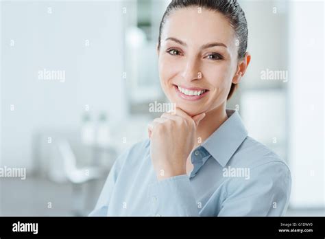 Pretty Young Woman Posing With Hand On Chin And Smiling At Camera Room