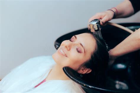 Happy Woman Having Her Hair Washed In A Professional Salon Stock Image