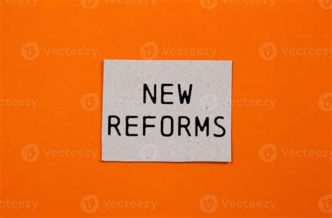 New Reforms Message Written On Paper Piece With Orange Background Conceptual New Reforms Symbol