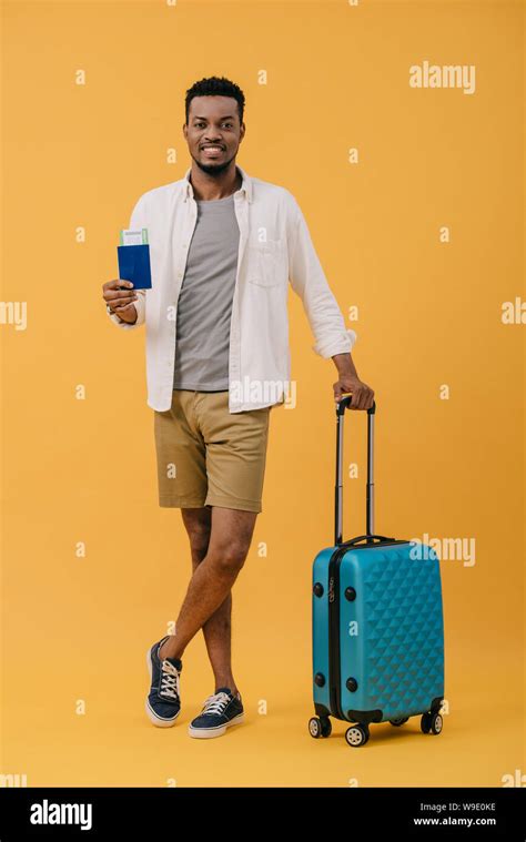Cheerful African American Man Holding Passport With Air Ticket And