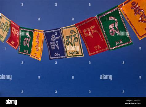 Tibetan Buddhist Flags Against Blue Background Text On Flags Om Mani