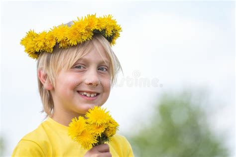 Boy With White Hair Wears Yellow T Shirt And Wreath Of Flowers Holds