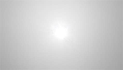 A Sun Shining Through A Cloudy Sky With The Sun Shining Through It