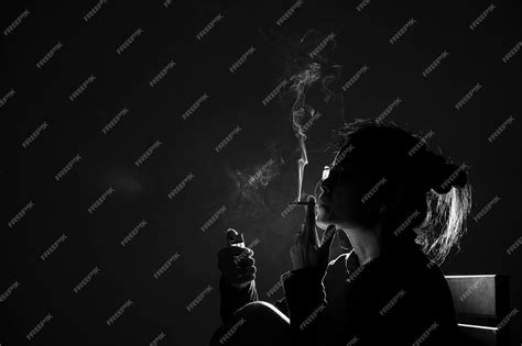 Premium Photo Portrait Of Man Smoking Cigarette Against Black Background