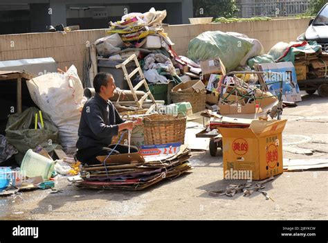 Shenzhen China March 26 2016 A Garbage Collector Is Binding Recyclable Materials To Earn