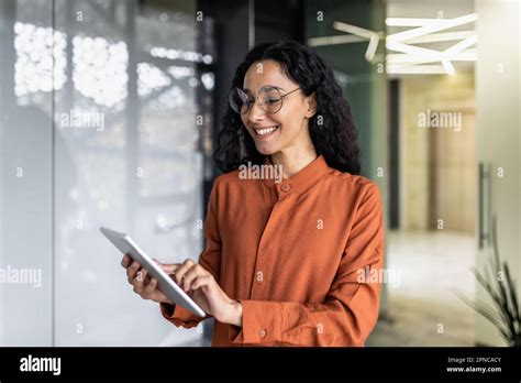 Indian Female Programmer Standing Inside The Office With A Tablet Computer In Her Hands The