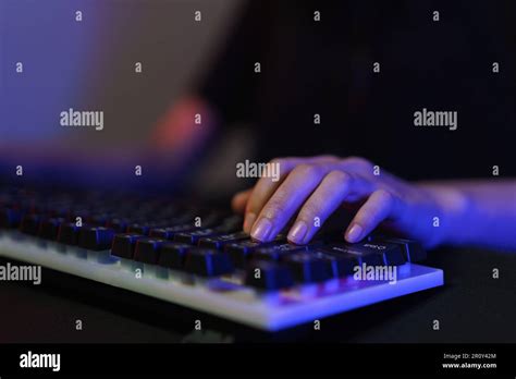 Female Cyber Hacker Gamer Using Keyboard And Mouse To Playing Games Or Hacking Programming