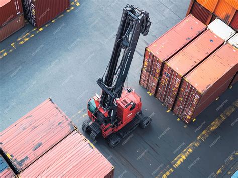 A Reach Stacker Lifting And Stacking Shipping Containers At A Container Terminal Premium Ai