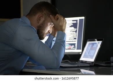 Worried Programmer Working Late Night On Stock Photo 1612695877