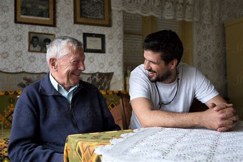 Grandfather And His Grandson Talking And Laughing While Spending Time