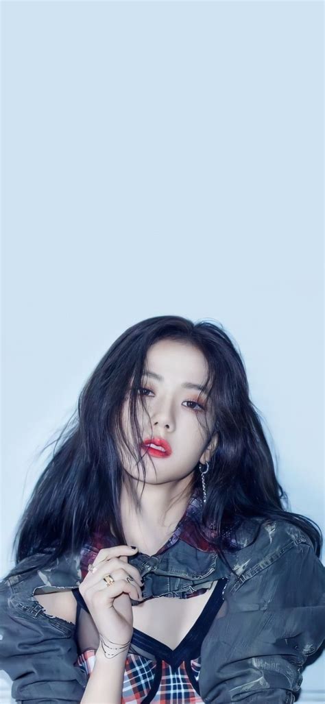 A Woman With Long Black Hair And Red Lipstick Posing For A Magazine