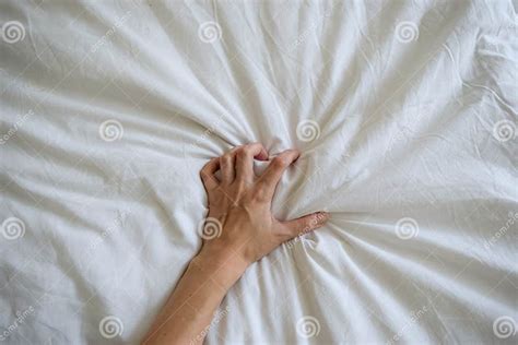 Close Up Woman Hand Pulling And Squeezing White Sheets In Ecstasy In