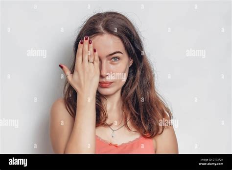 Cute Woman With Black Hair Covers Her Eye Witr Hand Face Close Up