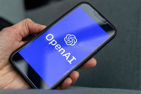 Woman`s Hand Holding An Iphone With Openai Logo Chatgpt And Chat Bot Culture Artificial