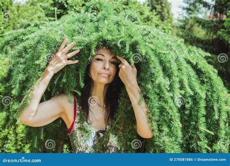 Portrait Of A Beautiful Girl With Hair From Green Branches Of Japanese