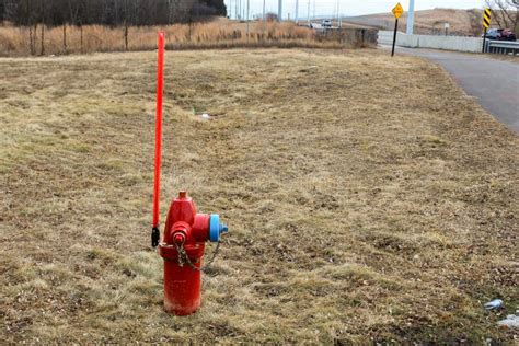 A Fire Hydrant In Winter With Long Red Stem Snow Marker For Cold