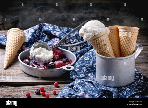 Homemade Vanilla Ice Cream In Wafer Cones And Empty Waffer Cones Served In Metal Bowl With