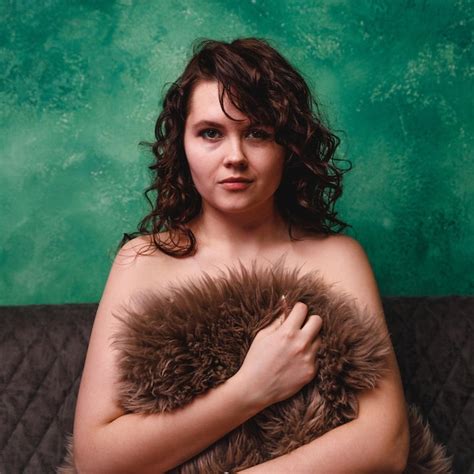 Premium Photo Portrait Of Young Woman Sitting On Grass