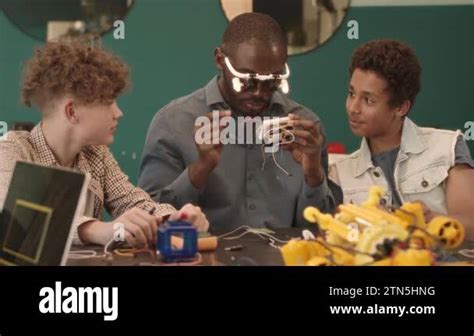 Waist Up Slowmo Of African American Male Teacher And Two Diverse