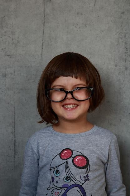 Premium Photo Smiling Girl Standing Against Wall