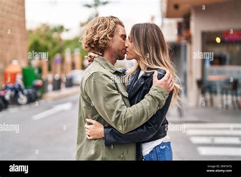 Man And Woman Couple Hugging Each Other And Kissing At Street Stock