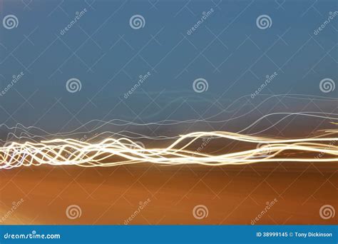 White Light Trails Against Blue Dusk Sky Stock Image Image Of Glow Highway