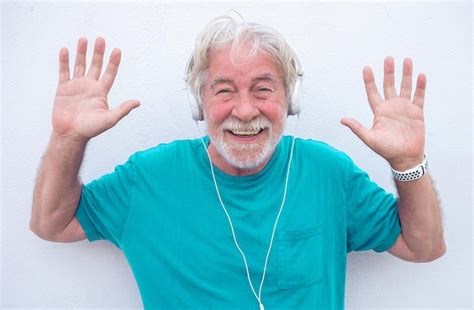 Premium Photo Cheerful Elderly Man In Blue Tshirt Wearing Headphones