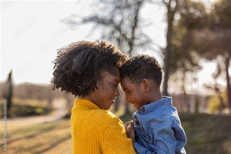 Mother And Son Touching Foreheads In Park Stock Photo Adobe Stock