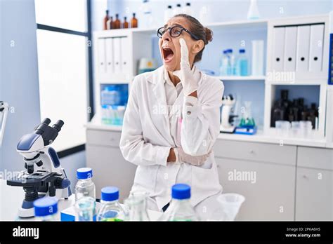 Young Woman Working At Scientist Laboratory Clueless And Confused With