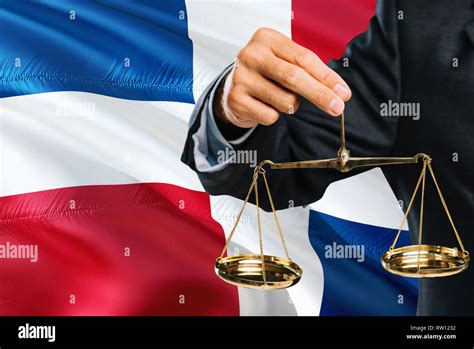Dominican Judge Is Holding Golden Scales Of Justice With Dominican