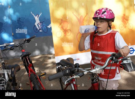 A Young Girl Cyclist Drinks Liquids In The Mall During Londons First