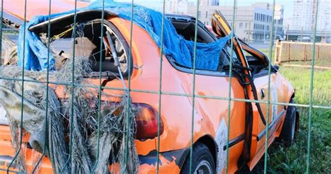 Premium Photo A Crashed Orange Car With A Dented Body And Roof Sits