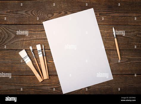 A Clean White Sheet And Brushes On A Textured Background With Space To