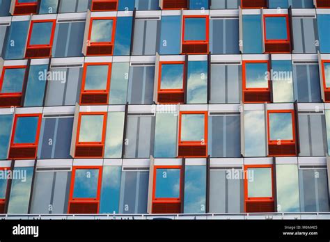 Red Outline Window Pattern With Reflecting Windows Of A Cloudy Blue Sky Exterior Urban Apartment