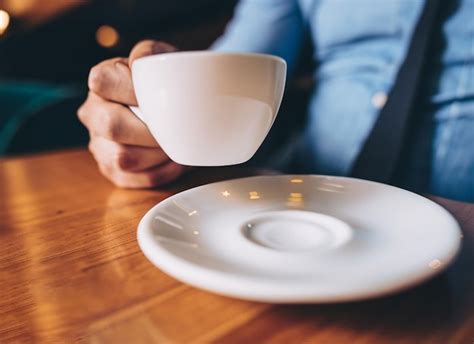 Premium Ai Image Business Man Drinking Coffee In A Cafe
