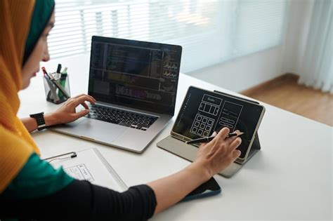 Premium Photo Front End Developer Checking Wireframe On Table Screen