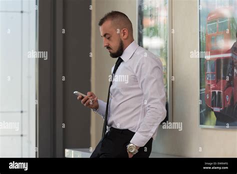 Business Man Reading Text Message On A Mobile In A Modern Office Stock
