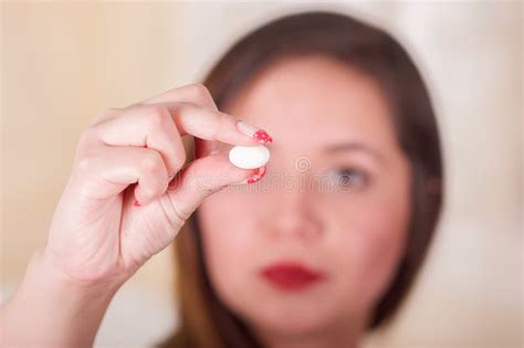 Portrait Of A Young Woman Holding In Her Hand A Soft Gelatin Vaginal