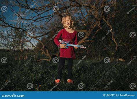 Cute Adorable Young Girl Playing Guitar Toy Outdoor Girl Pretending To