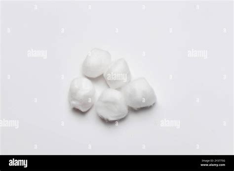 Balls Of Fluffy White Cotton Wool Against A White Background Stock