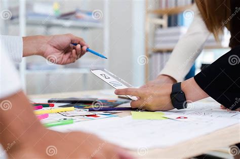 Creative Team Collaborating On Ux Ui Design Project With Wireframes And Prototypes Stock Image