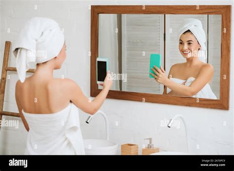 Beautiful Happy Woman In Towel Taking Selfie In Front Of Mirror In The