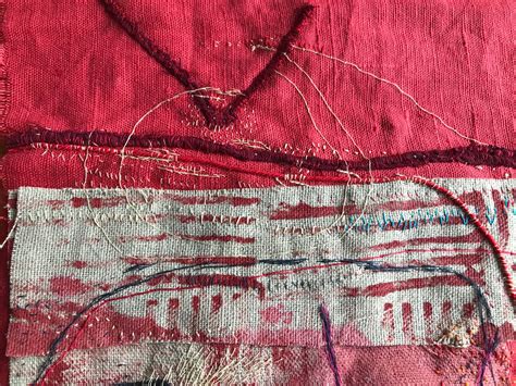Strips of crimson fabric closely overstitched to create shapes ...