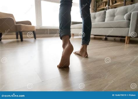 Close Up Barefoot Young Woman Walking On Wooden Floor Royalty Free