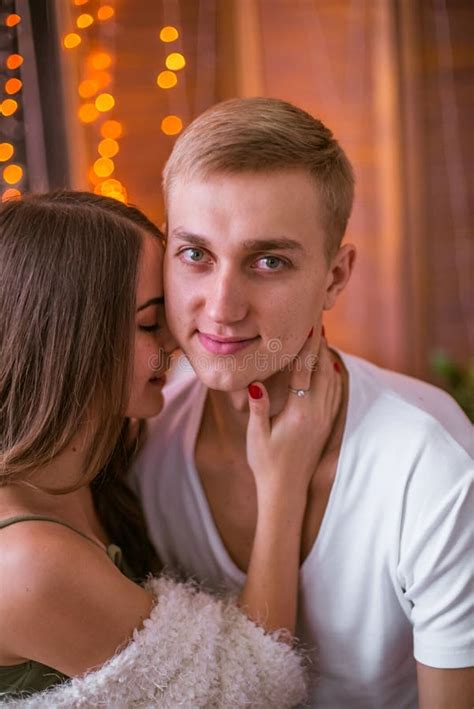 A Young And Attractive Couple A Guy And A Girl Are Sitting And Hugging
