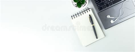 Top View Of Modern White Office Desk With Computer Keyboard Blank Notebook Page And Other